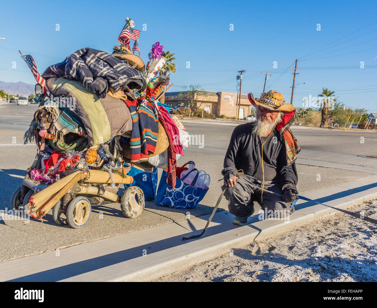 A homeless male character and his overloaded wheeled cart with his ...