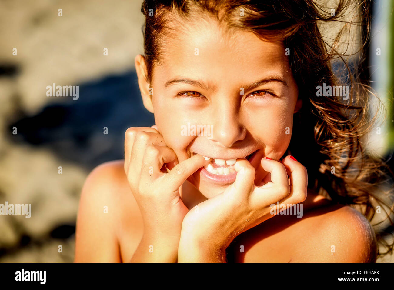 Beautiful eight year old girl smiling on the beach Stock Photo - Alamy