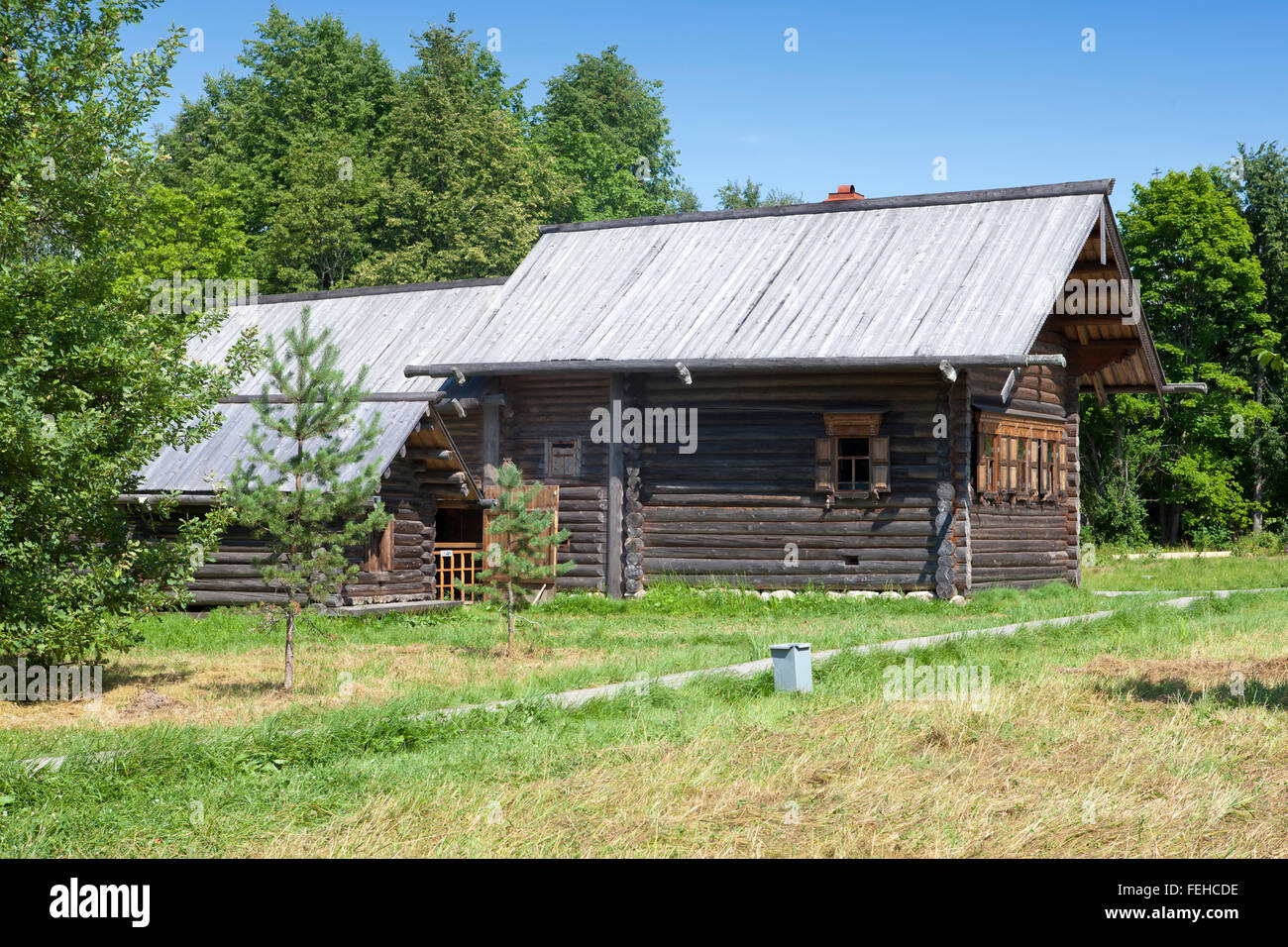 ancient log hut on a forest glade. Russia Stock Photo - Alamy