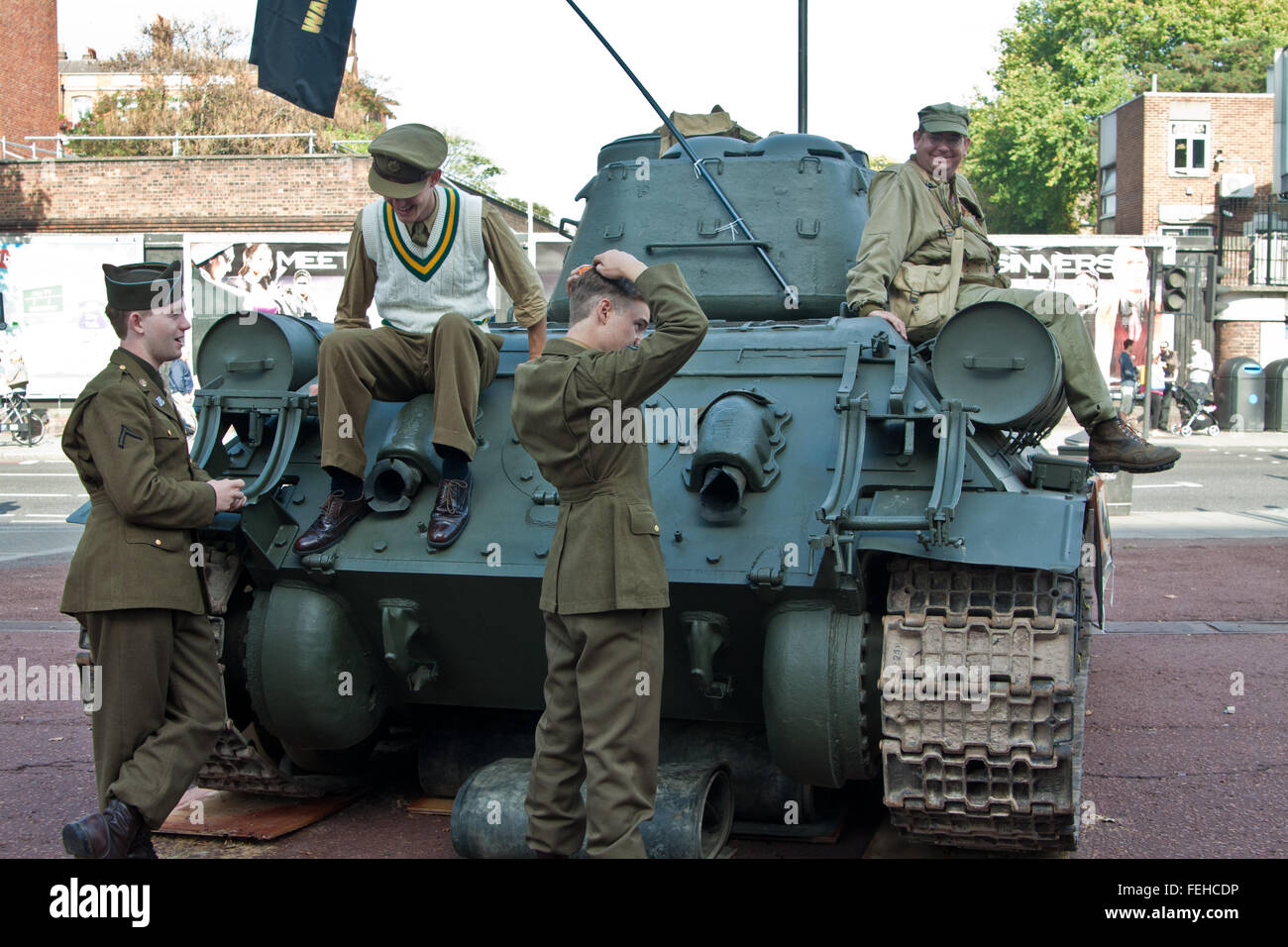 Men dressed in World War 2 outfits sitting on a tank Stock Photo - Alamy