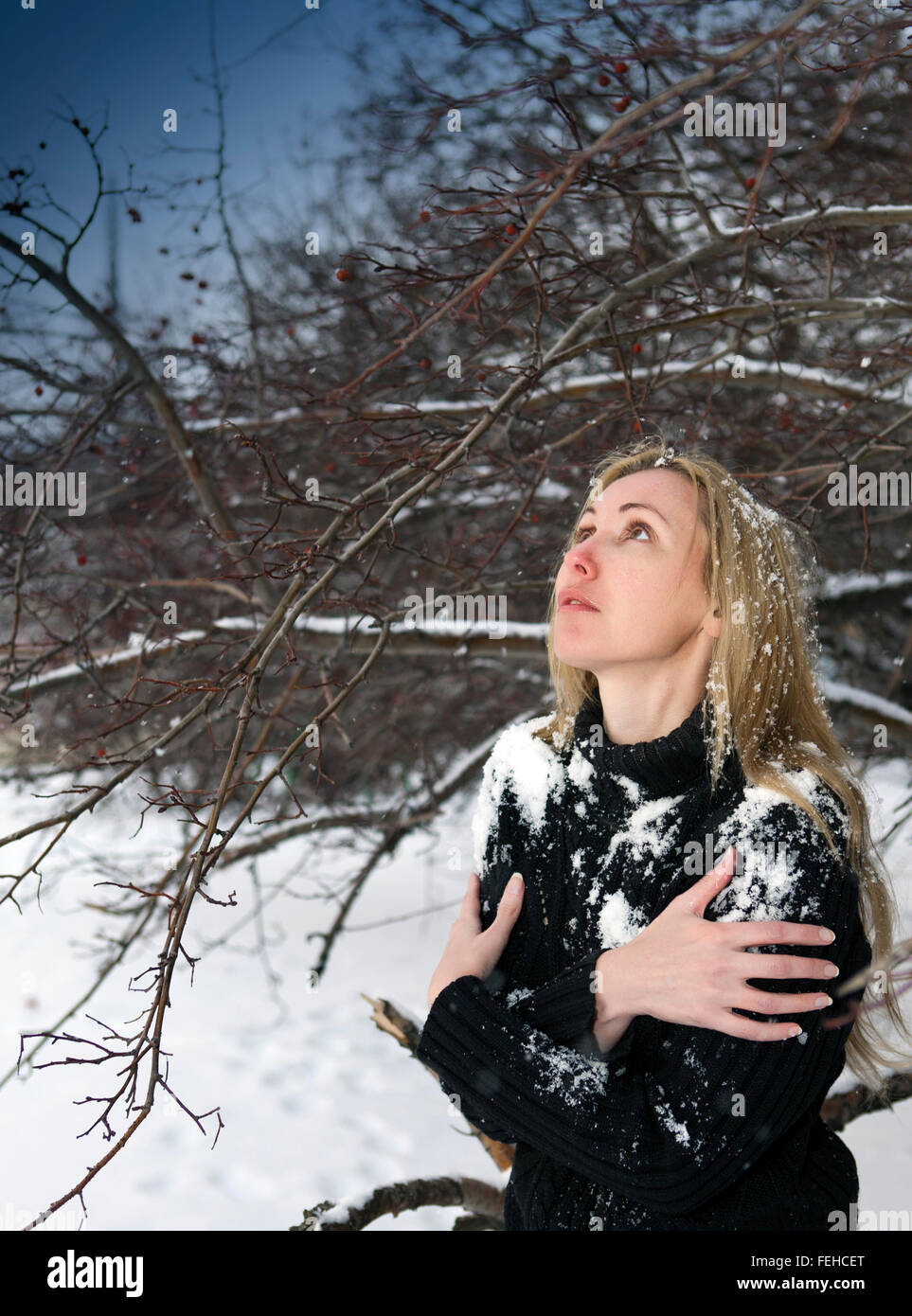 The young frozen woman stand under the falling snow Stock Photo - Alamy