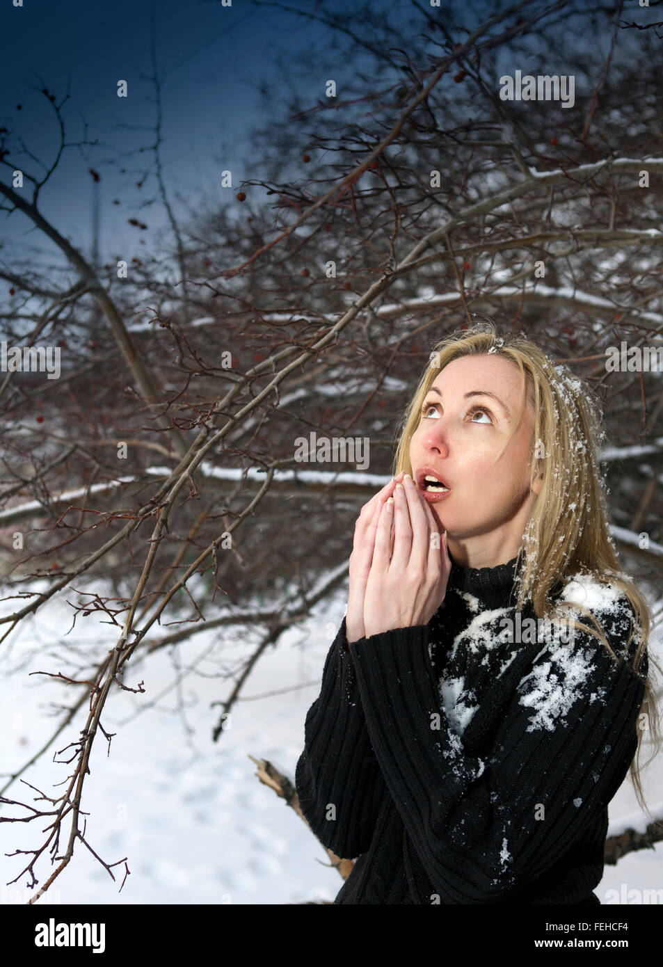 The young frozen woman stand under the falling snow Stock Photo - Alamy