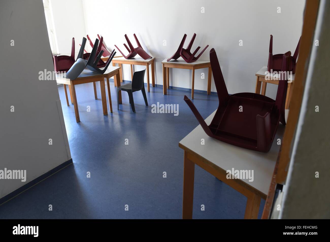 Chairs arranged on tables in the common room of the correctional ...
