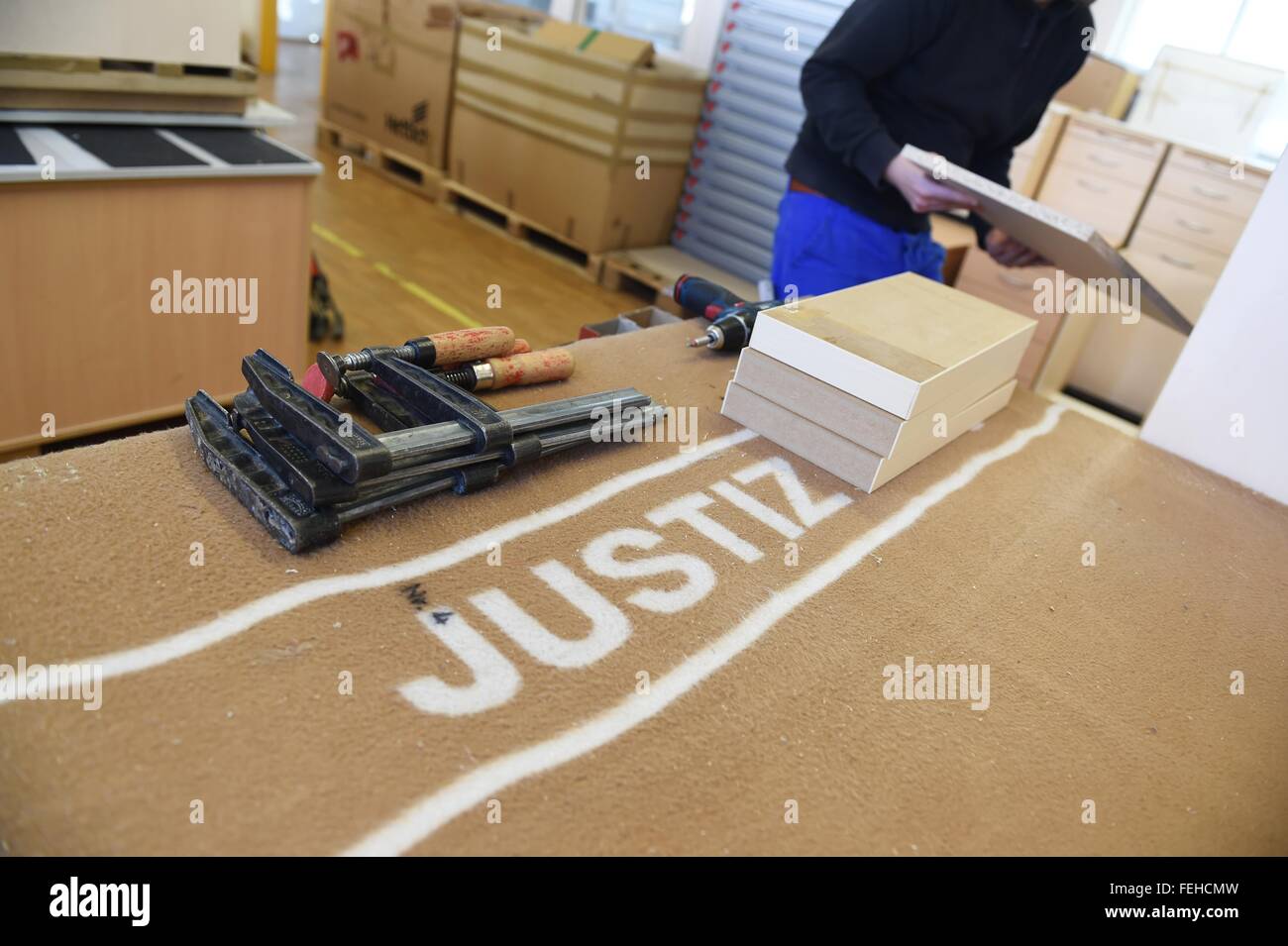 A prisoner sets up a shelf, with various tools pictured in the ...