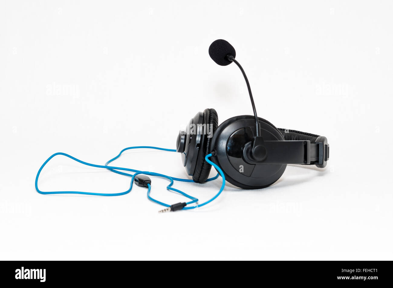 Earphones on blue background Cut Out Stock Images & Pictures - Alamy