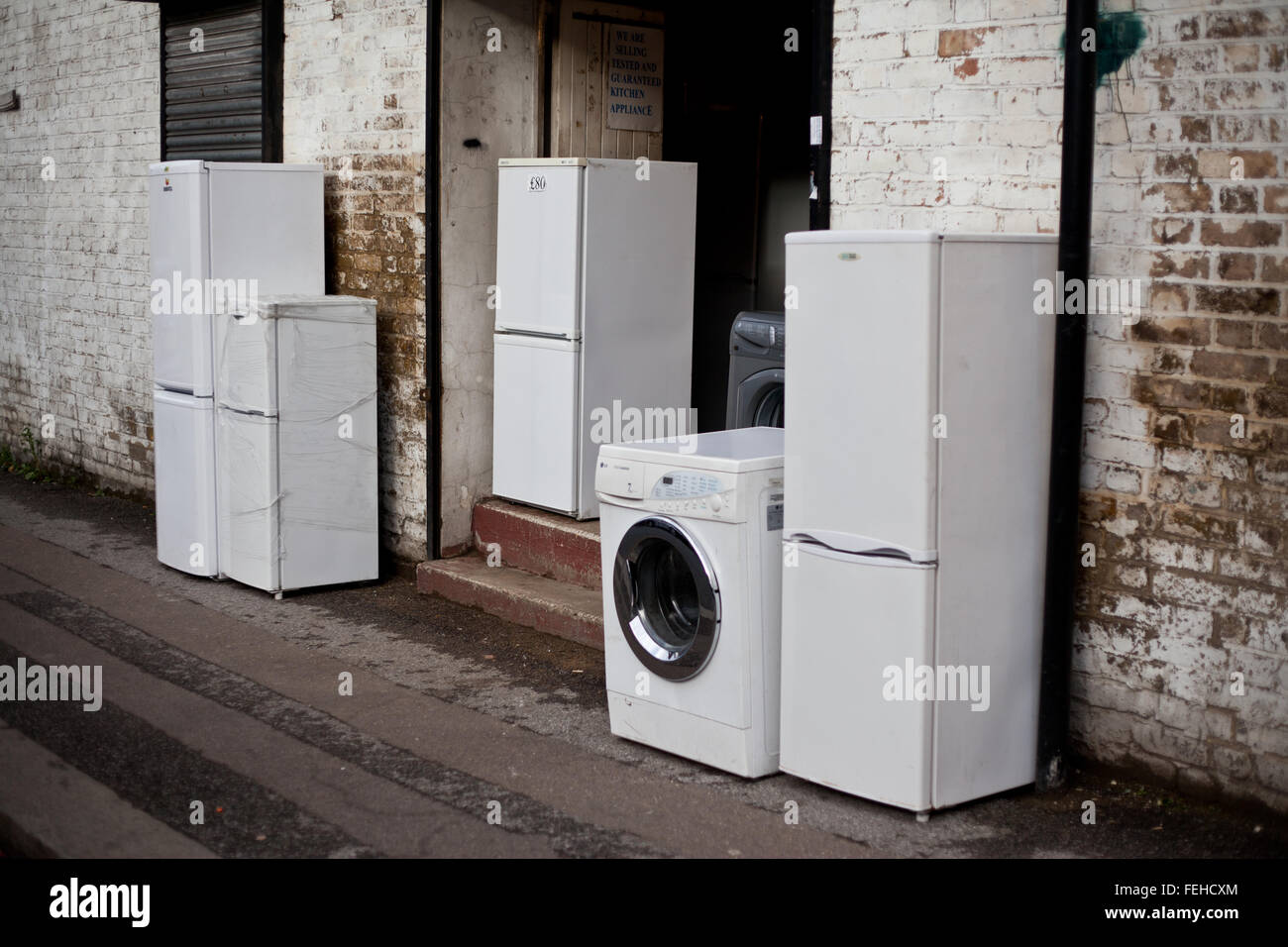 Fridges and washing machine outside shop on London side-street Stock ...