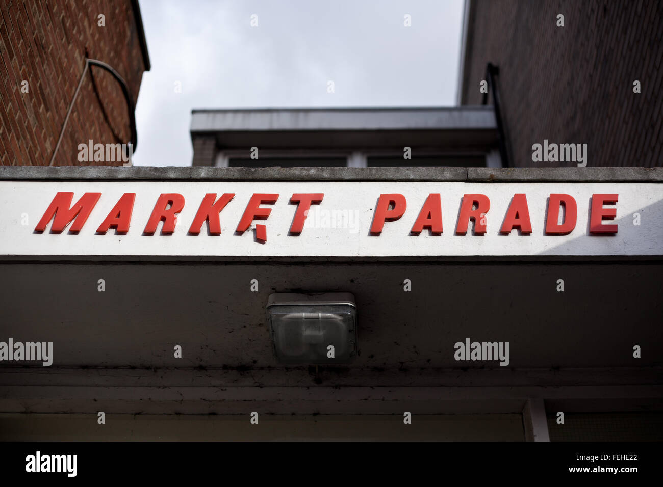 Red 'Market Parade' sign at entrance to flats on High Road Leyton, East ...