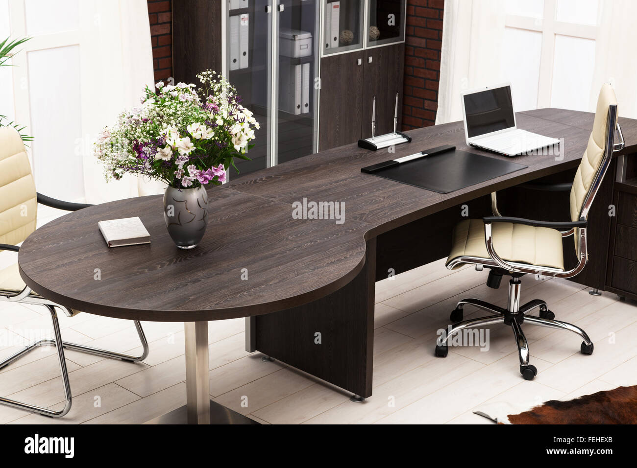 bouquet of flowers on a desk at modern office Stock Photo - Alamy