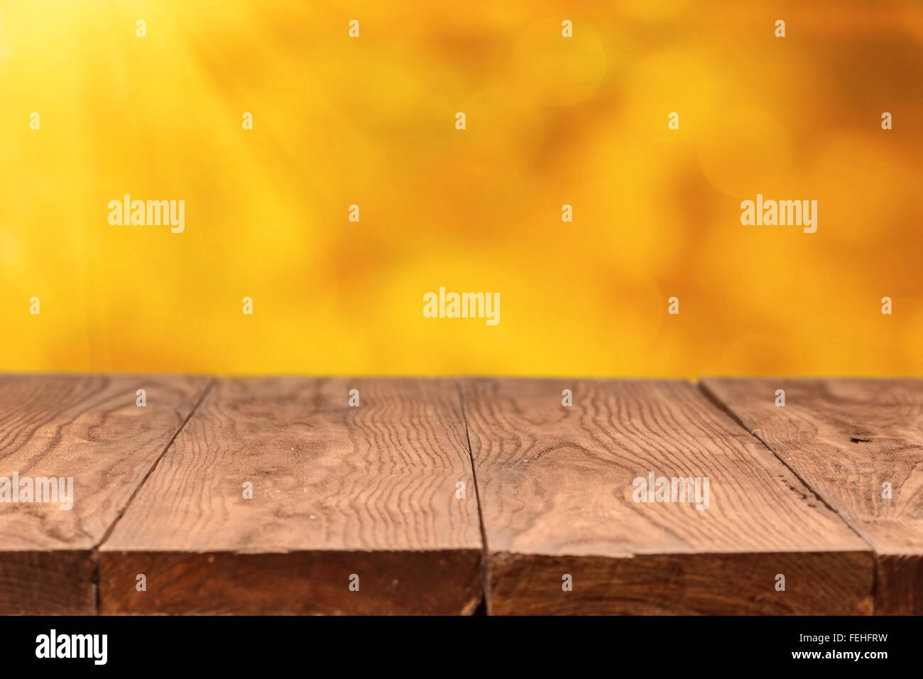 wooden table and backround with autumn leaves Stock Photo - Alamy