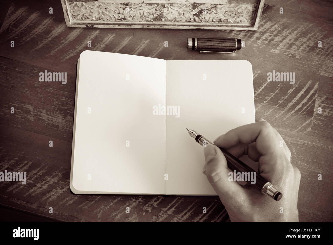 Retro effect and toned image of a woman hand writing a note with a ...