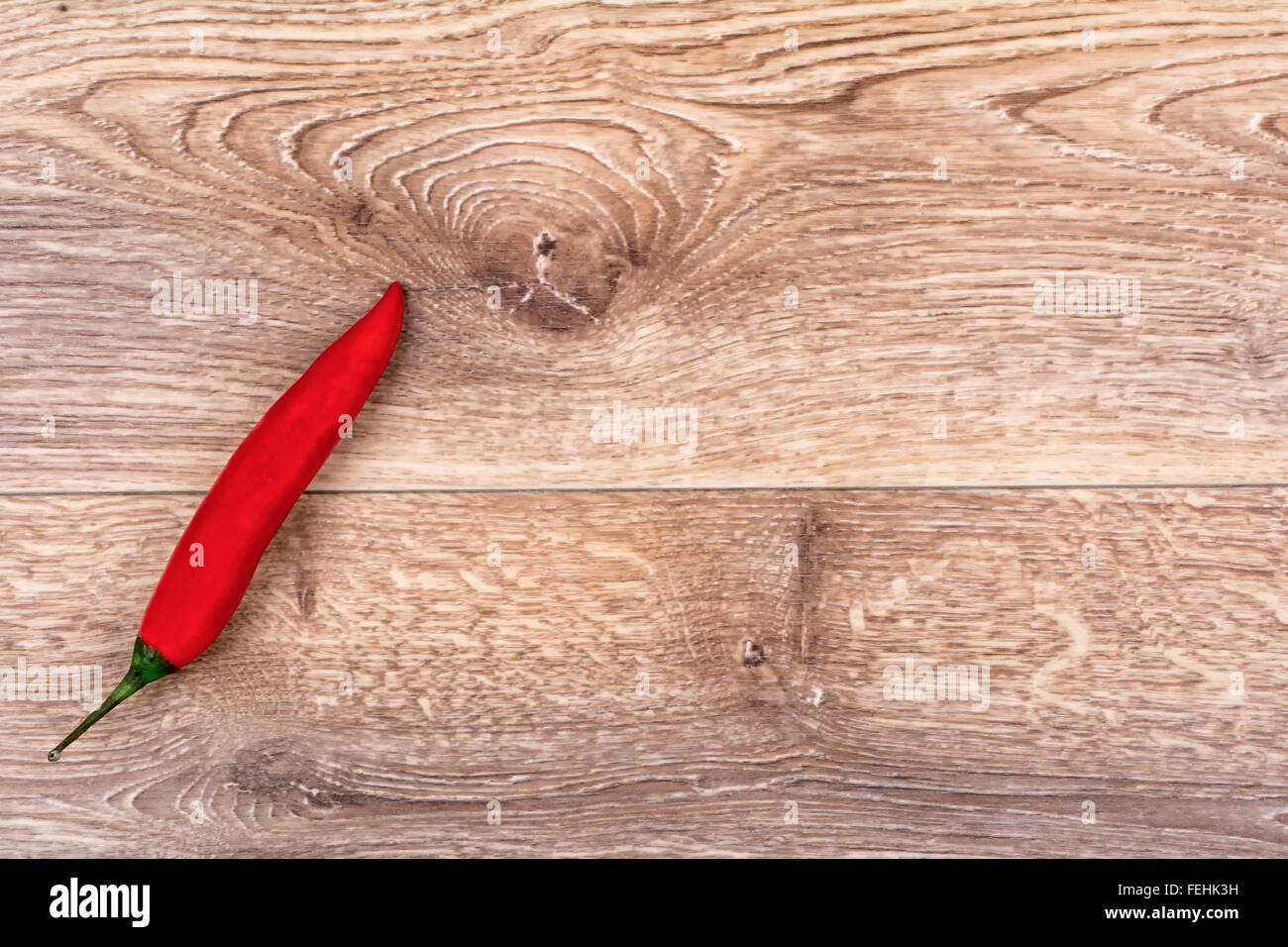Fresh red chilli on old wood background Stock Photo - Alamy
