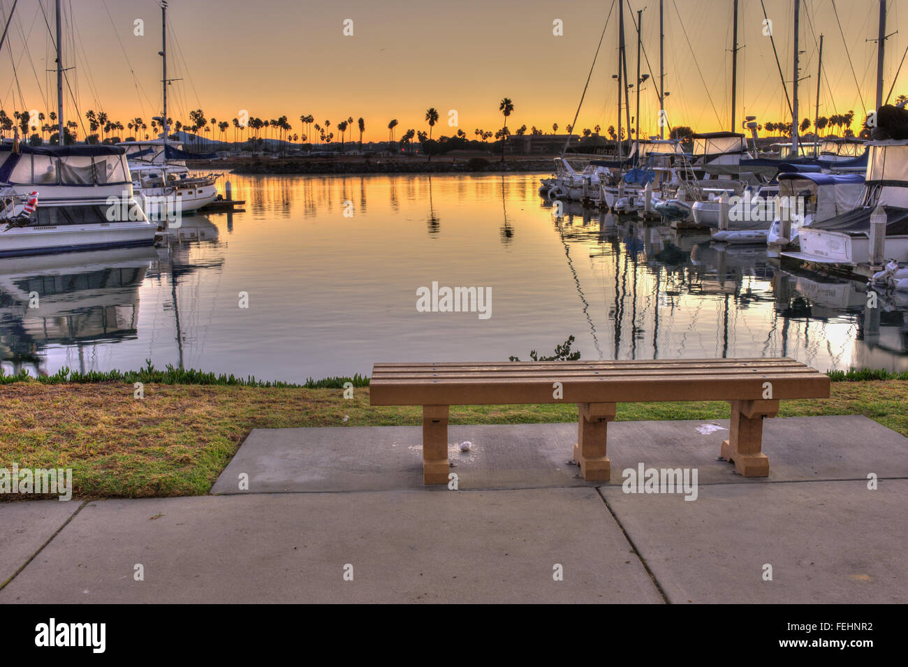 Sunrise bench in front of the boats Stock Photo - Alamy