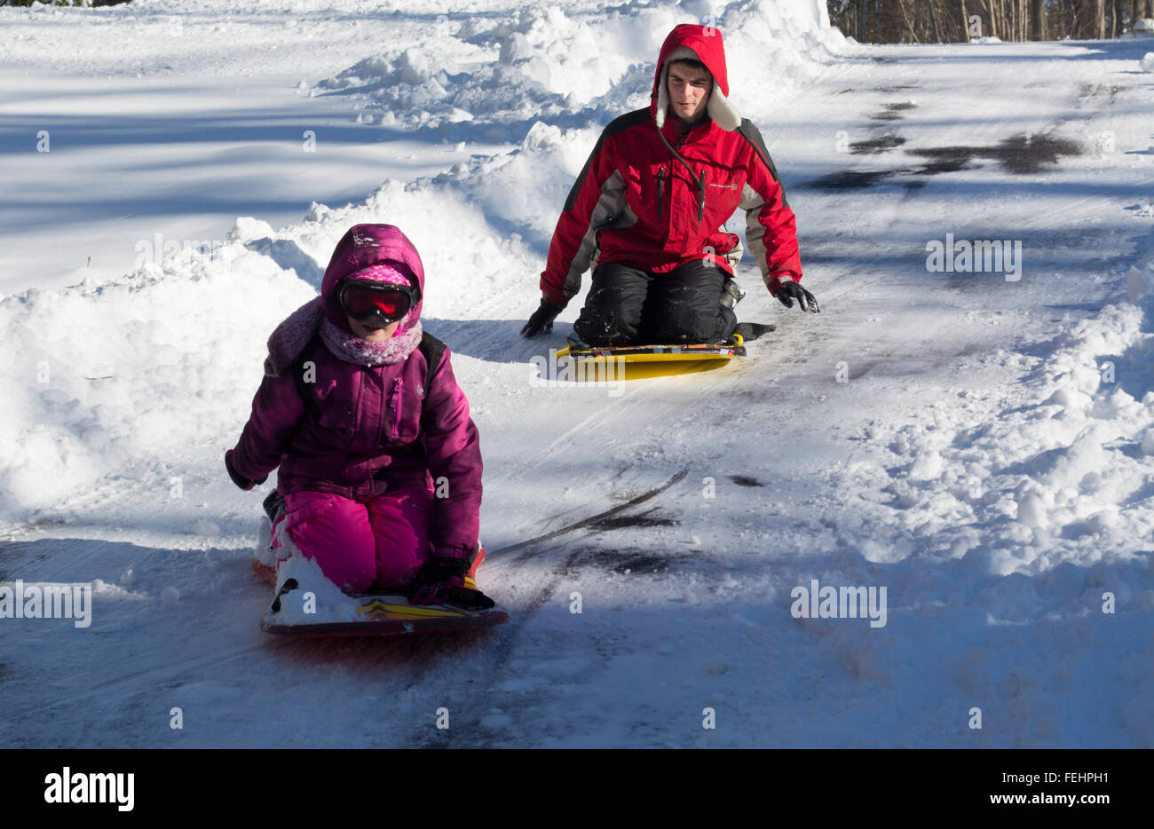Children sledding on the snow Stock Photo - Alamy