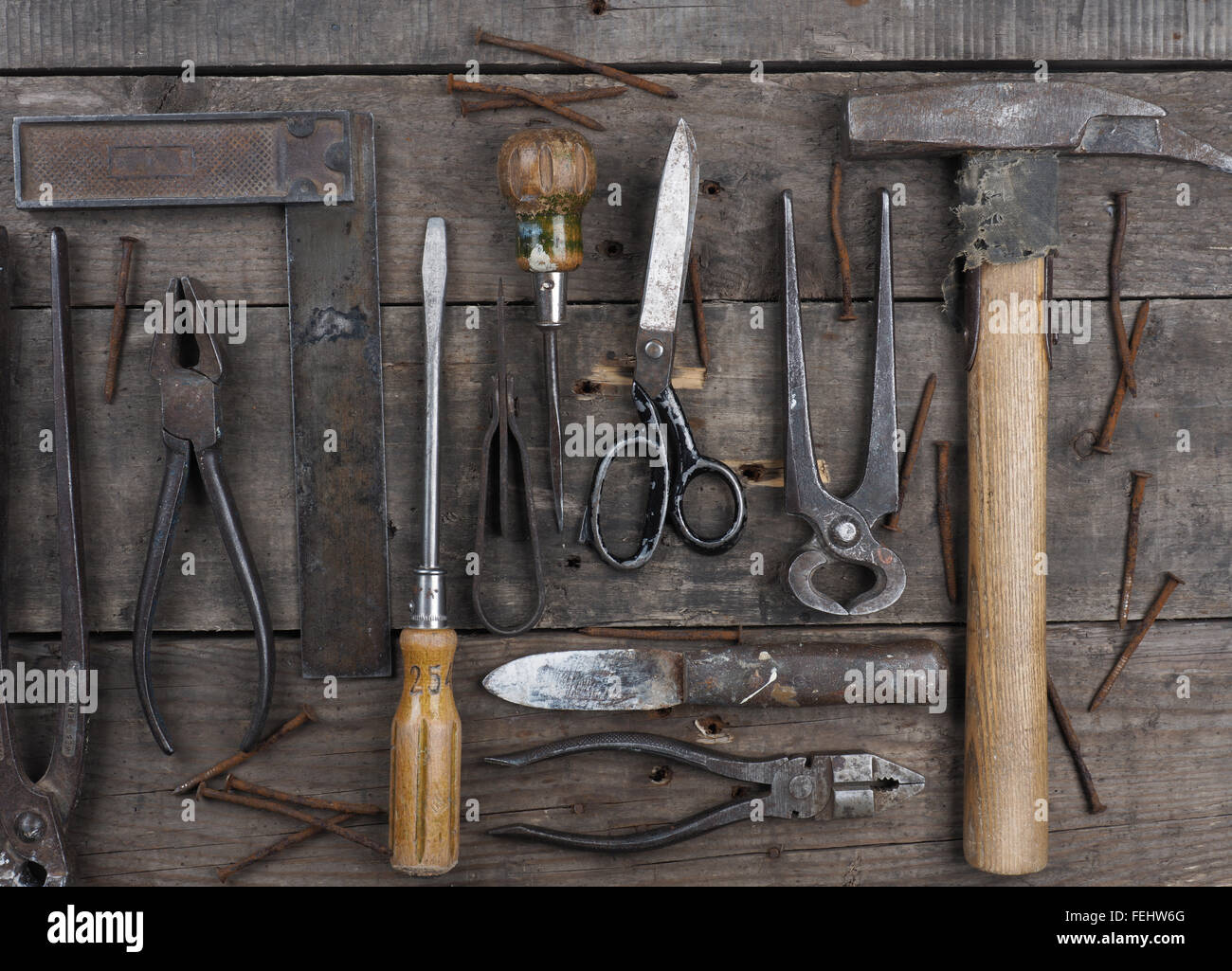 Old and rusty used tools on a rustic wooden table Stock Photo - Alamy