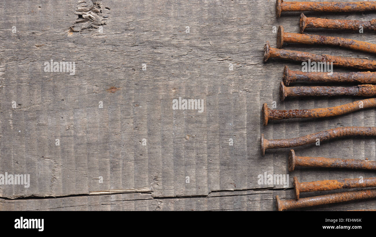 Rusty old nails on a rustic wooden table Stock Photo - Alamy