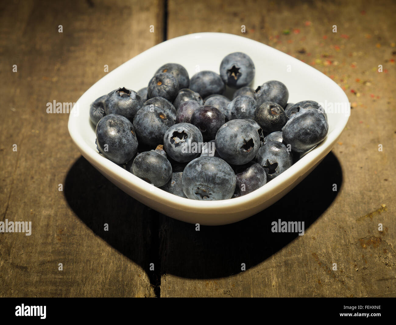 Fresh blueberries in a white bowl on a rustic wooden table Stock Photo ...