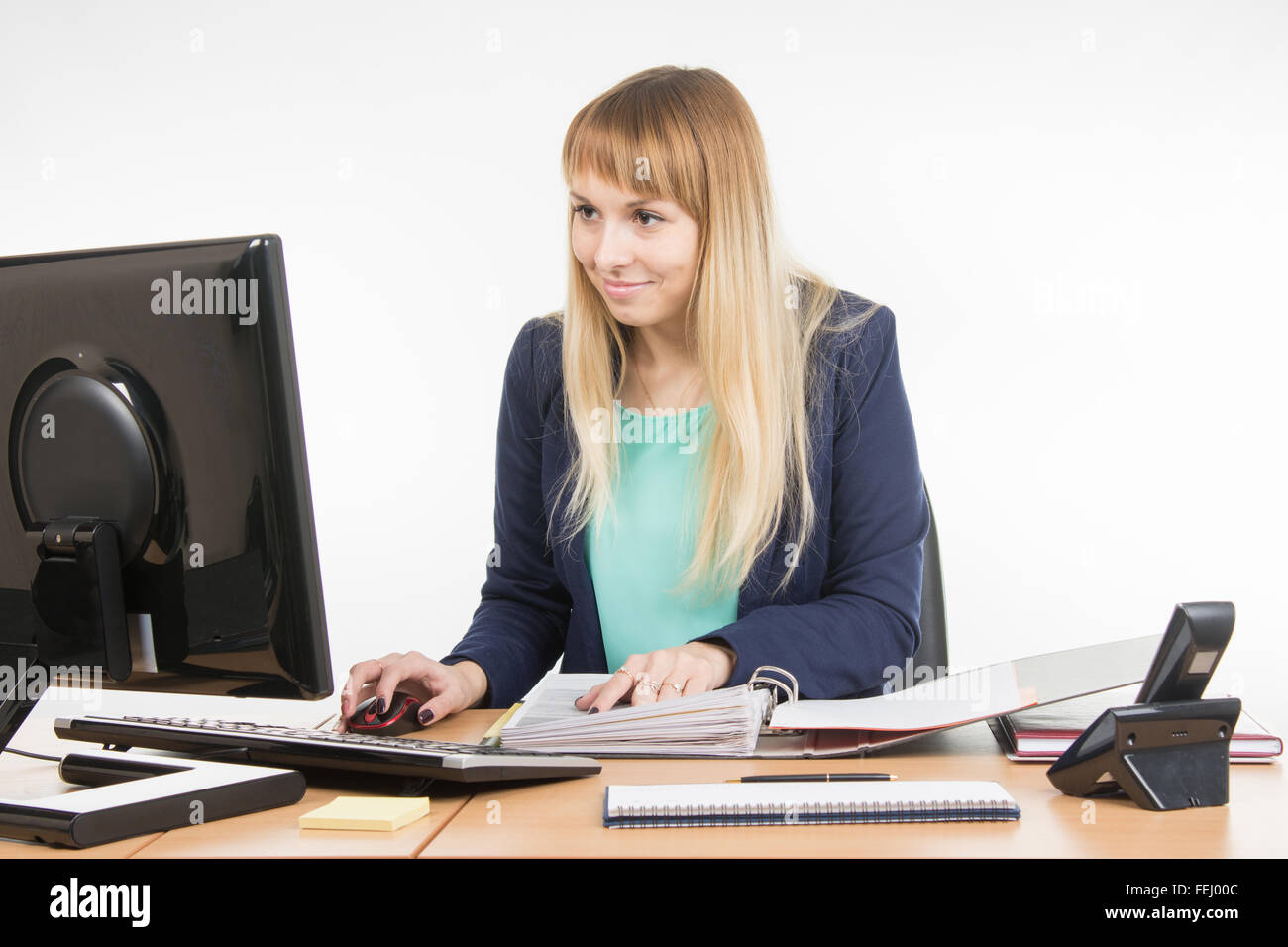 Young woman secretary sitting at office desk working, isolated on white ...