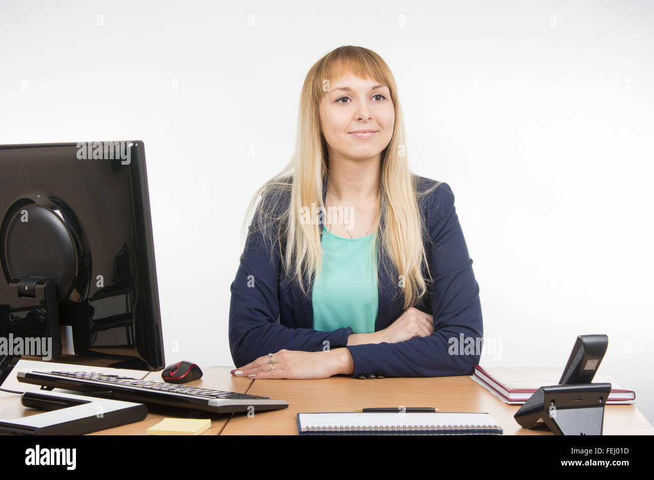 Young woman secretary sitting at office desk working, isolated on white ...