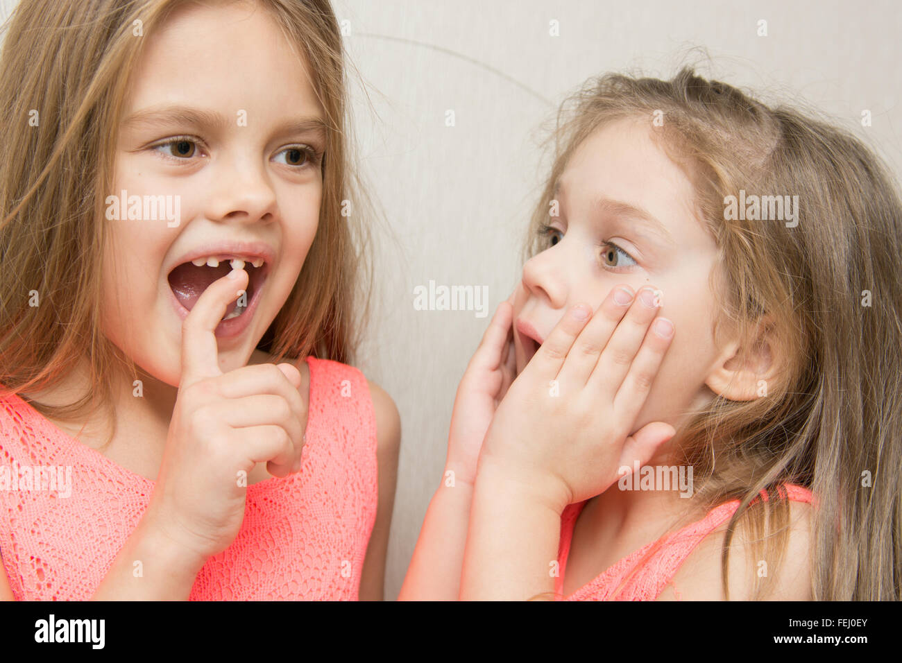 Six year old girl shows her sister a four wobbly front tooth milk Stock ...