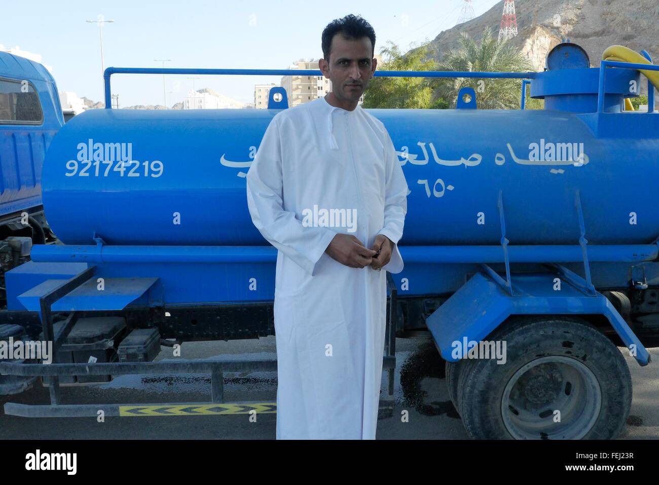 MUSCAT, OMAN Water truck and driver Stock Photo - Alamy