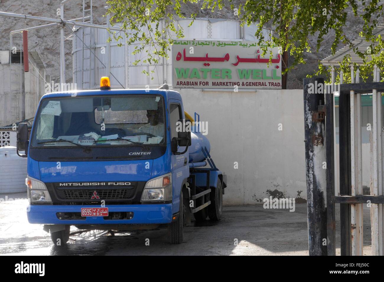 MUSCAT, OMAN Water truck and driver Stock Photo - Alamy