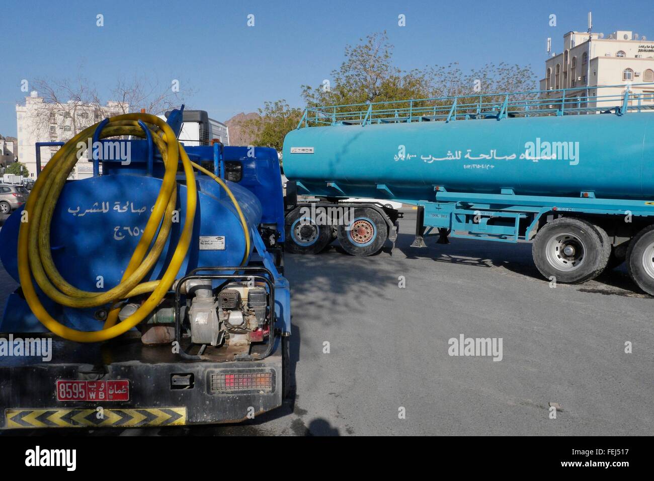 MUSCAT, OMAN Water truck and driver Stock Photo - Alamy
