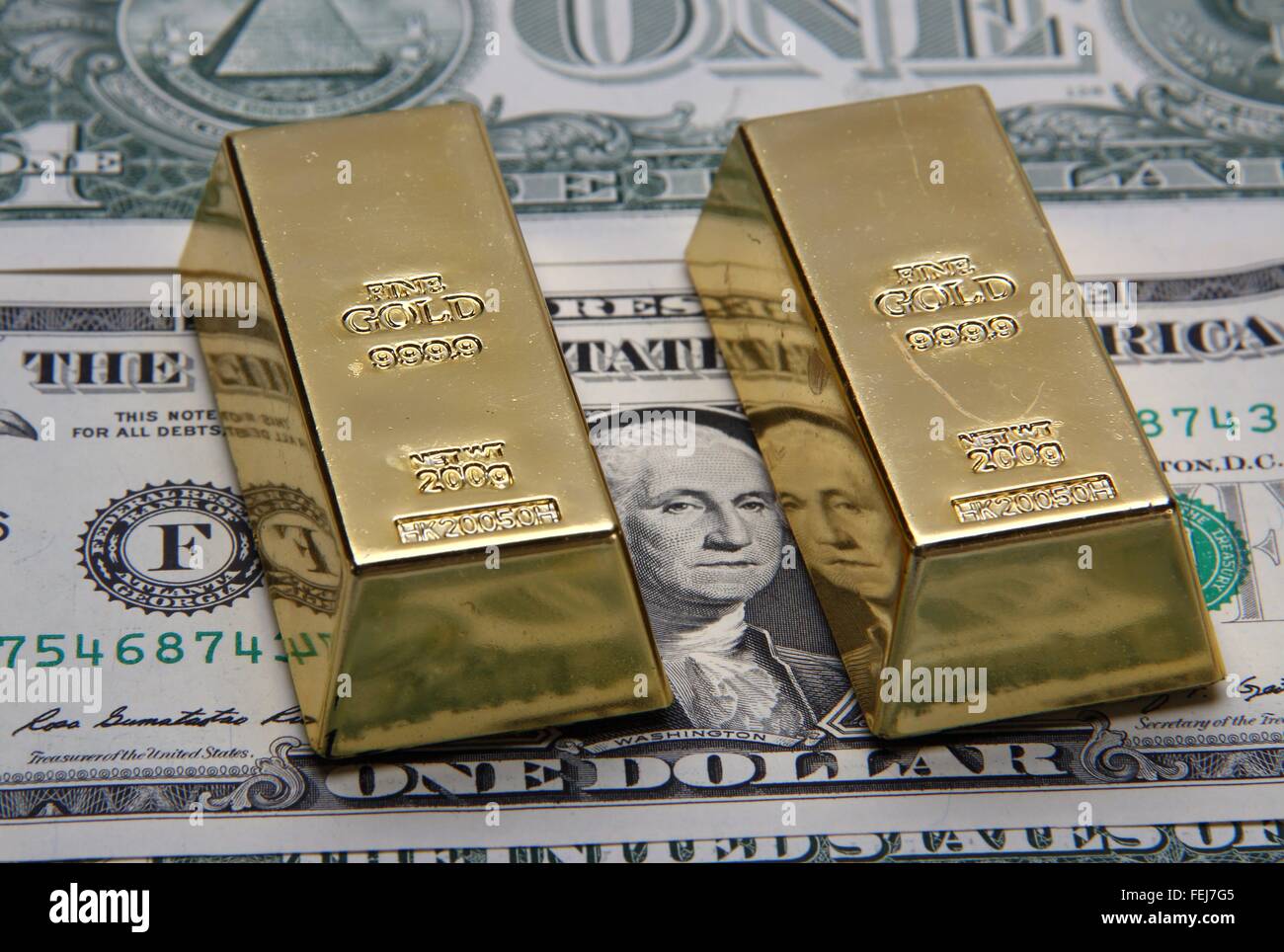 Two Gold Ingots With Dollar Banknotes Stock Photo - Alamy