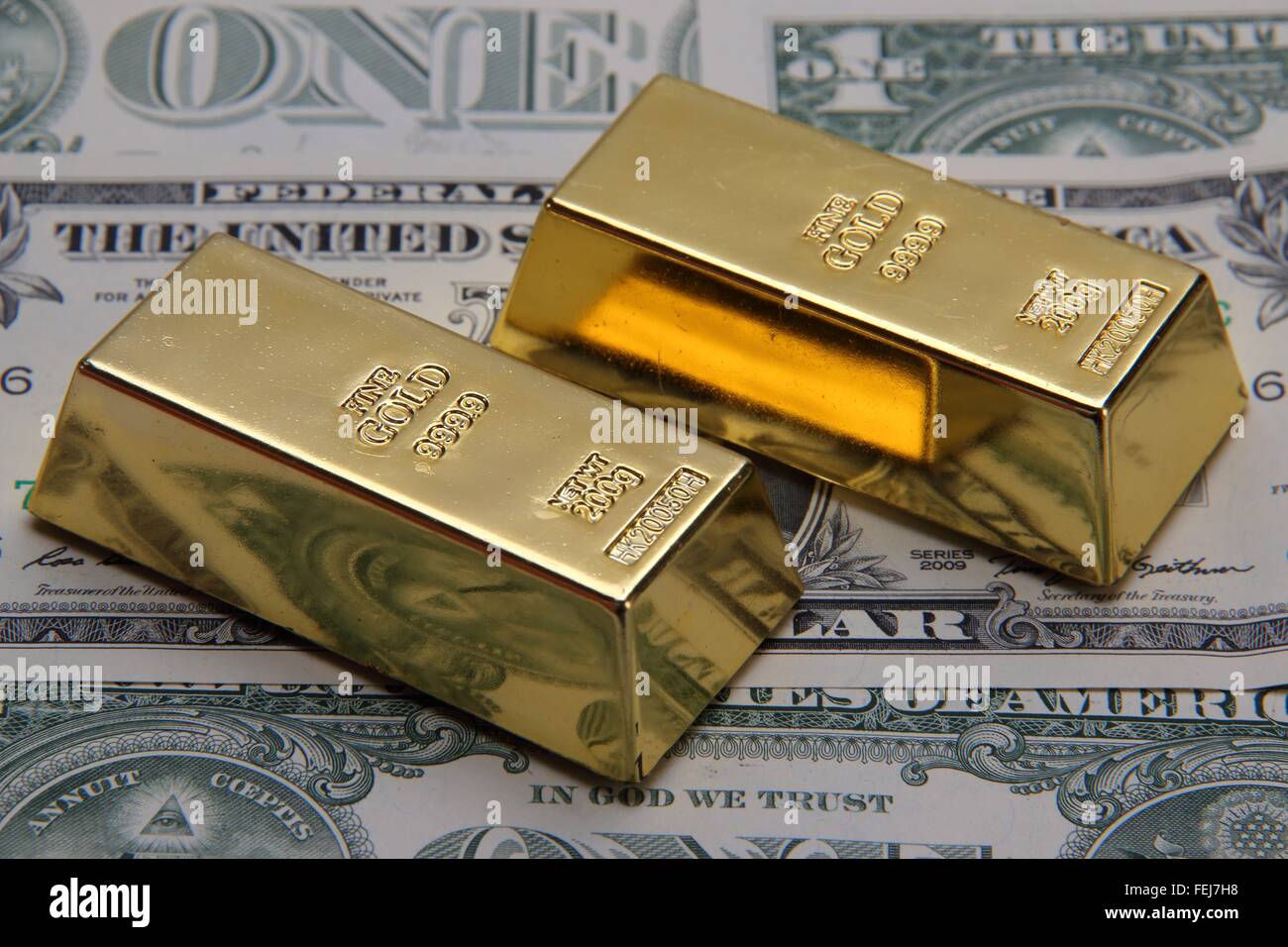Two Gold Ingots With Dollar Banknotes Stock Photo - Alamy