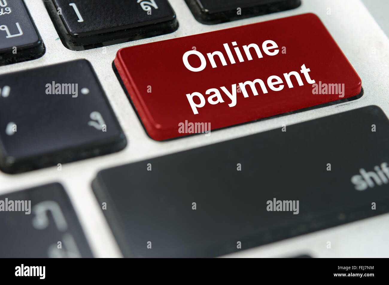 A keyboard with a red button Online payment Stock Photo - Alamy