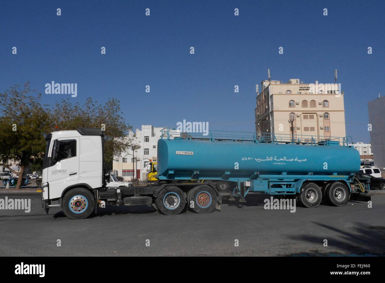 MUSCAT, OMAN Water truck and driver Stock Photo - Alamy