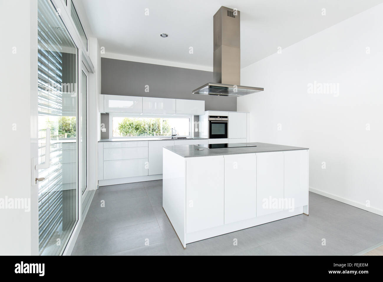 Interior of white kitchen with big windows Stock Photo - Alamy