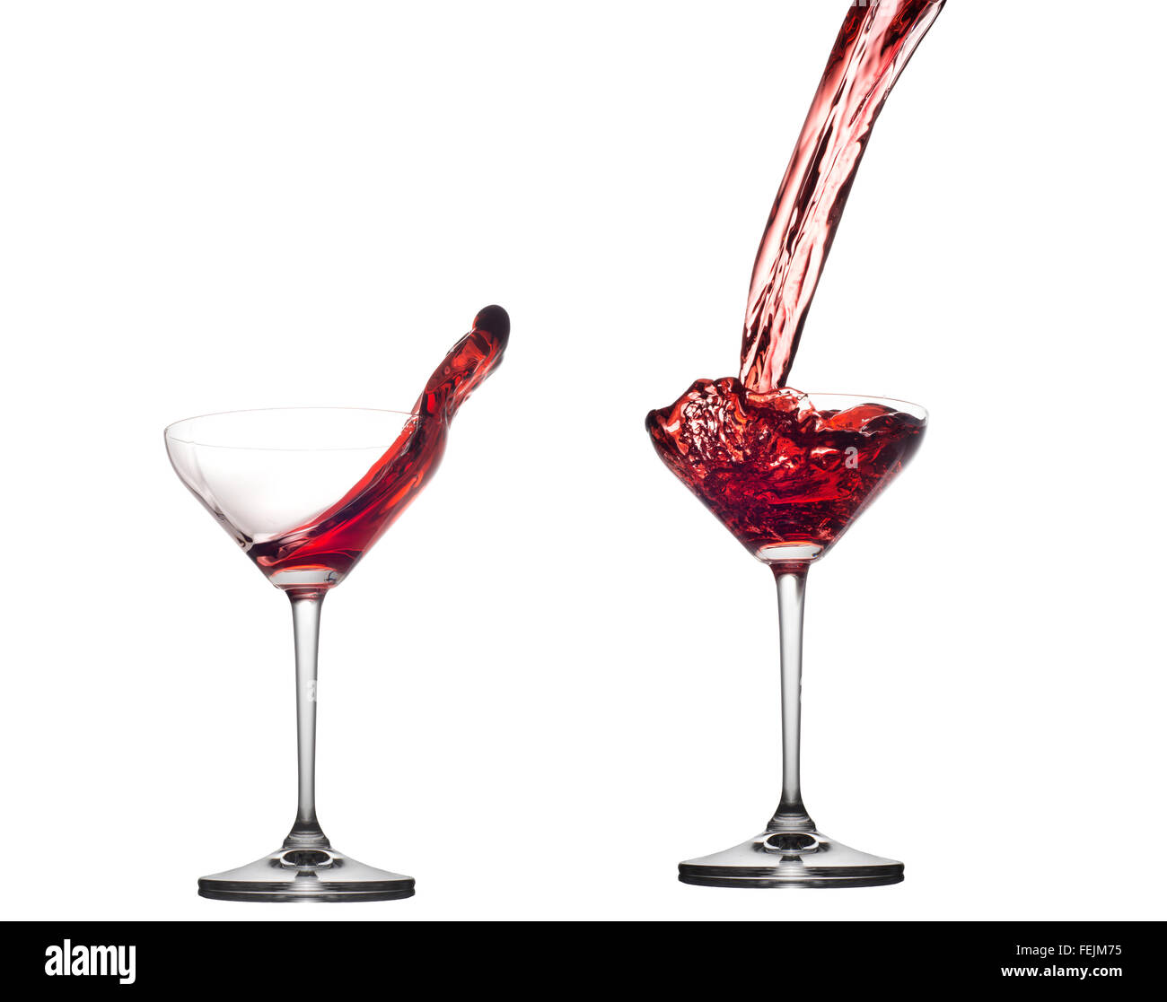 Red cocktail splashing from glass isolated on white background Stock ...