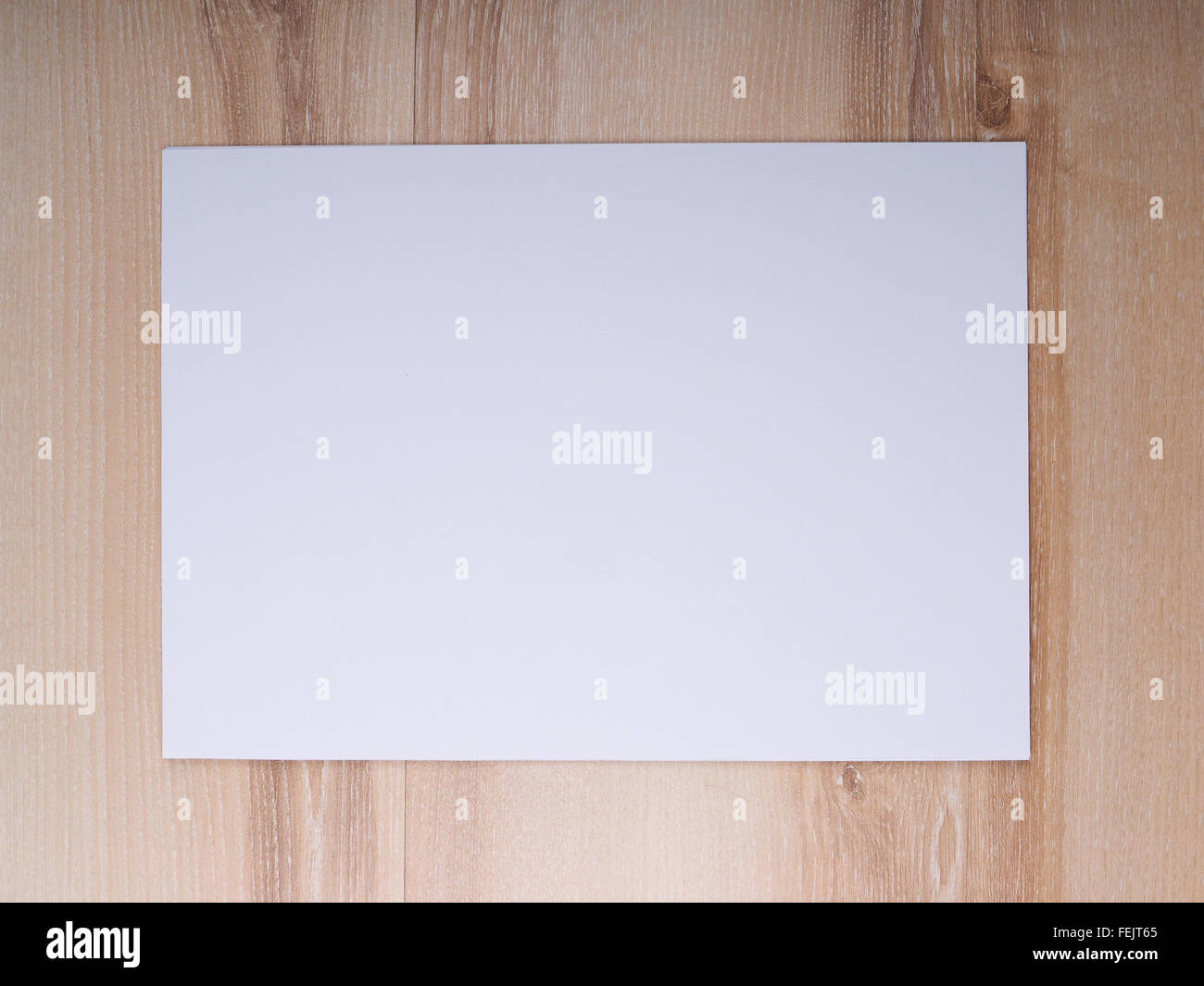 A4 paper on a wooden background Stock Photo - Alamy