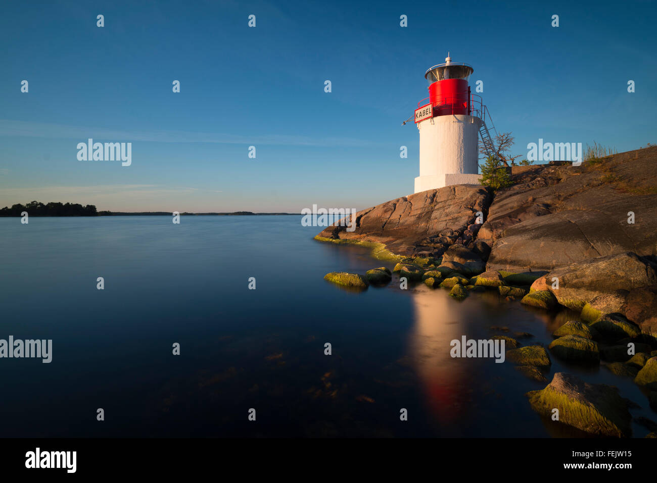Lighthouse on the rocky coast in the Swedish archipelago island Yxlan ...
