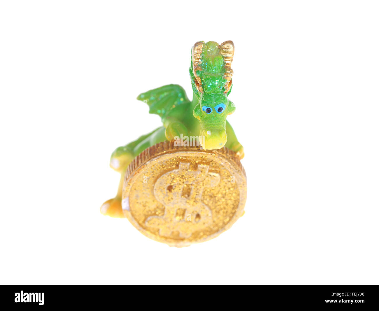 toy dragon with a coin on a white background Stock Photo - Alamy