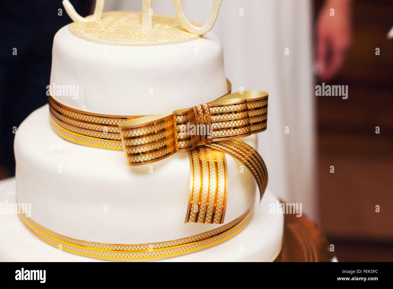 white wedding cake and gold tape Stock Photo - Alamy