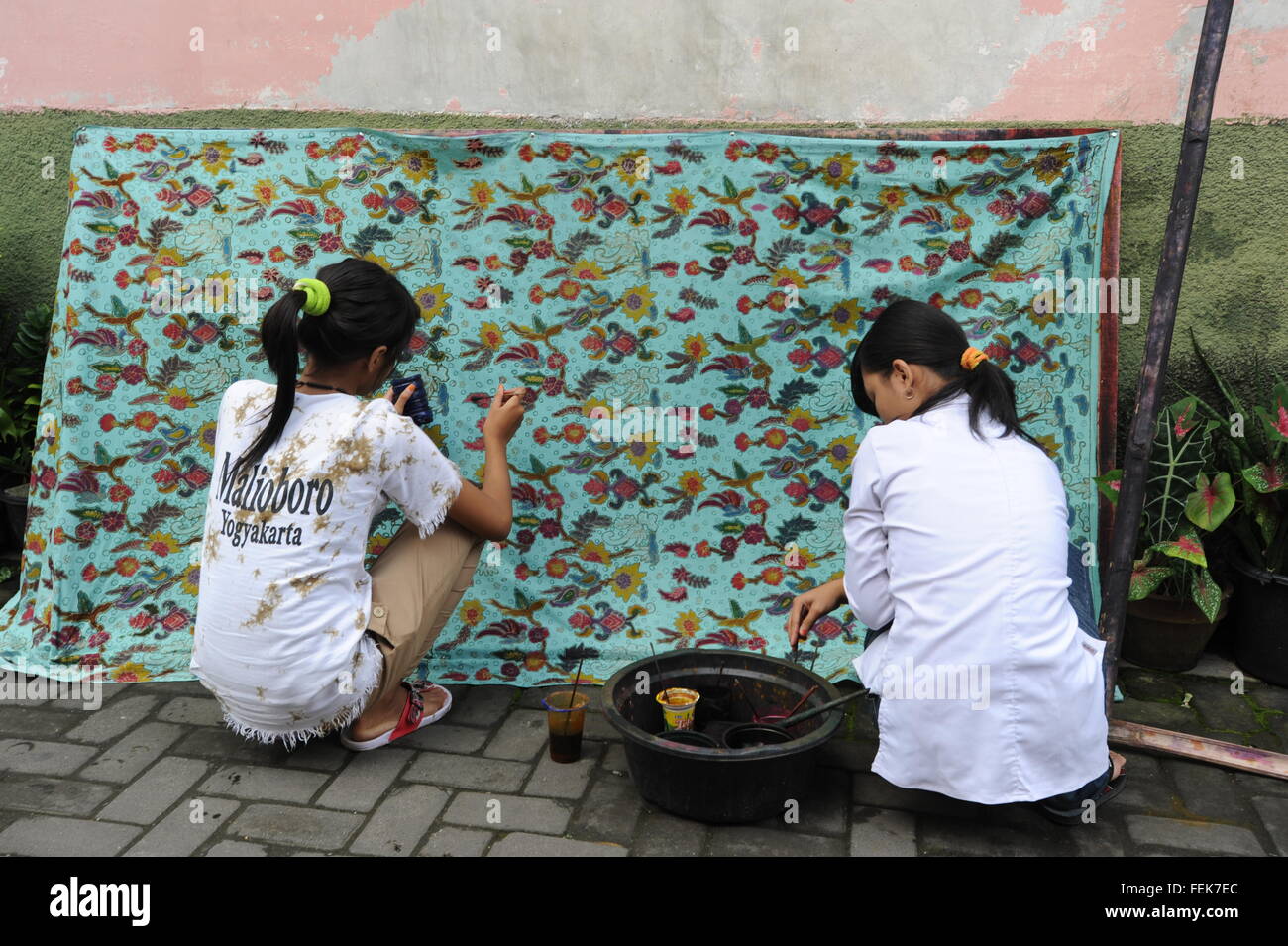 Two girls coloring batik artwork Stock Photo - Alamy