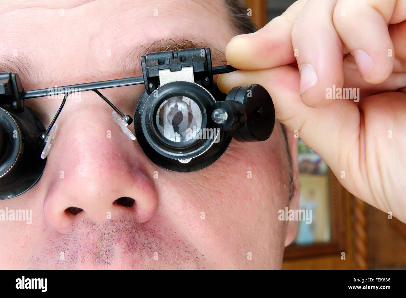 man holding his left hand microscopes special glasses on his face Stock ...
