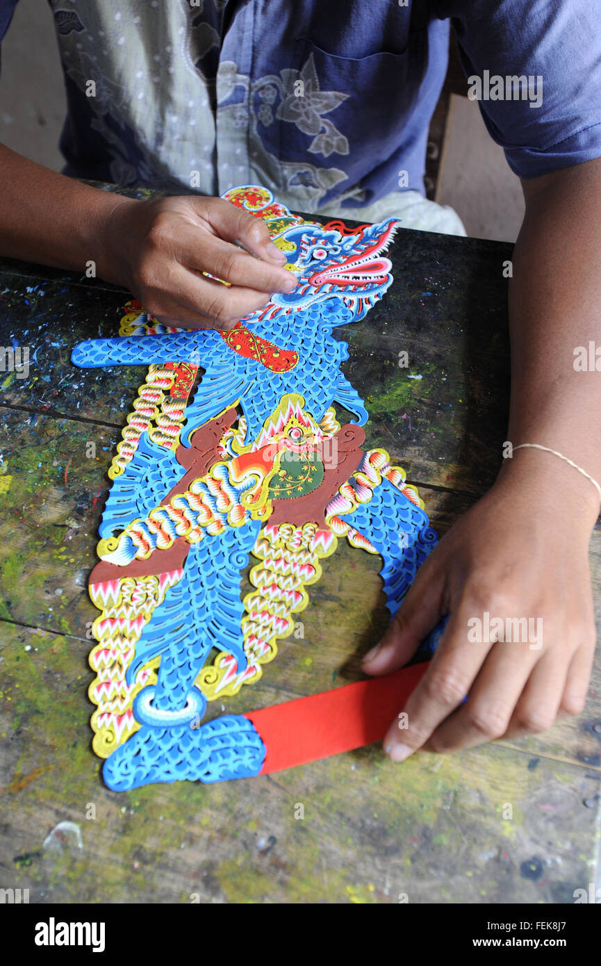 Man manufacturing a Wayang Golek puppet at Yogyakarta on Java ...