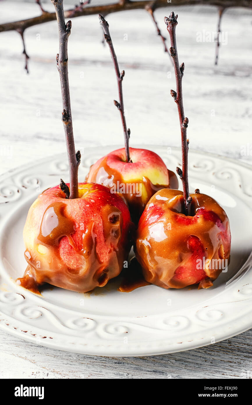 apples with toffee caramel decorated with branch Stock Photo - Alamy