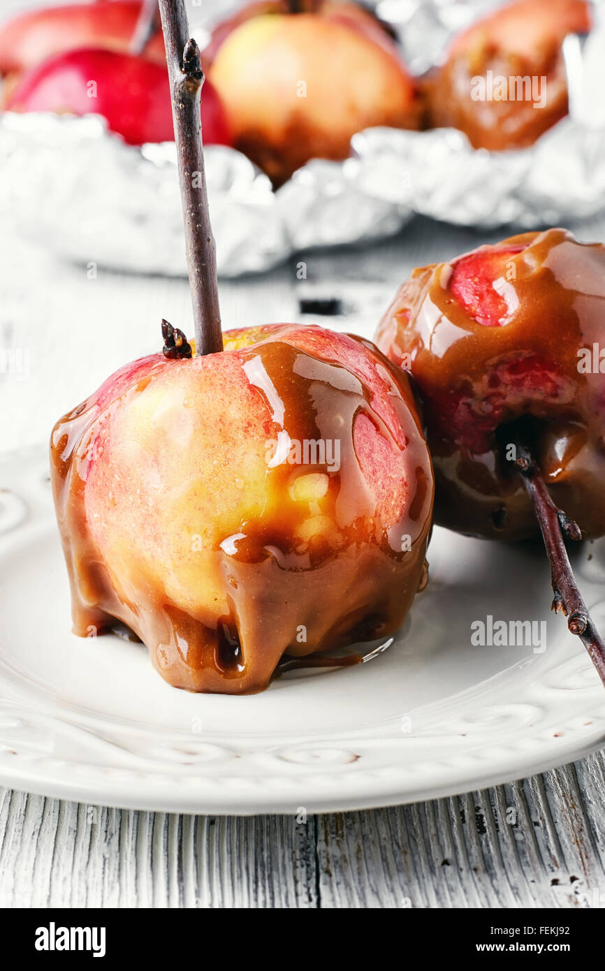 apples with toffee caramel decorated with branch Stock Photo - Alamy