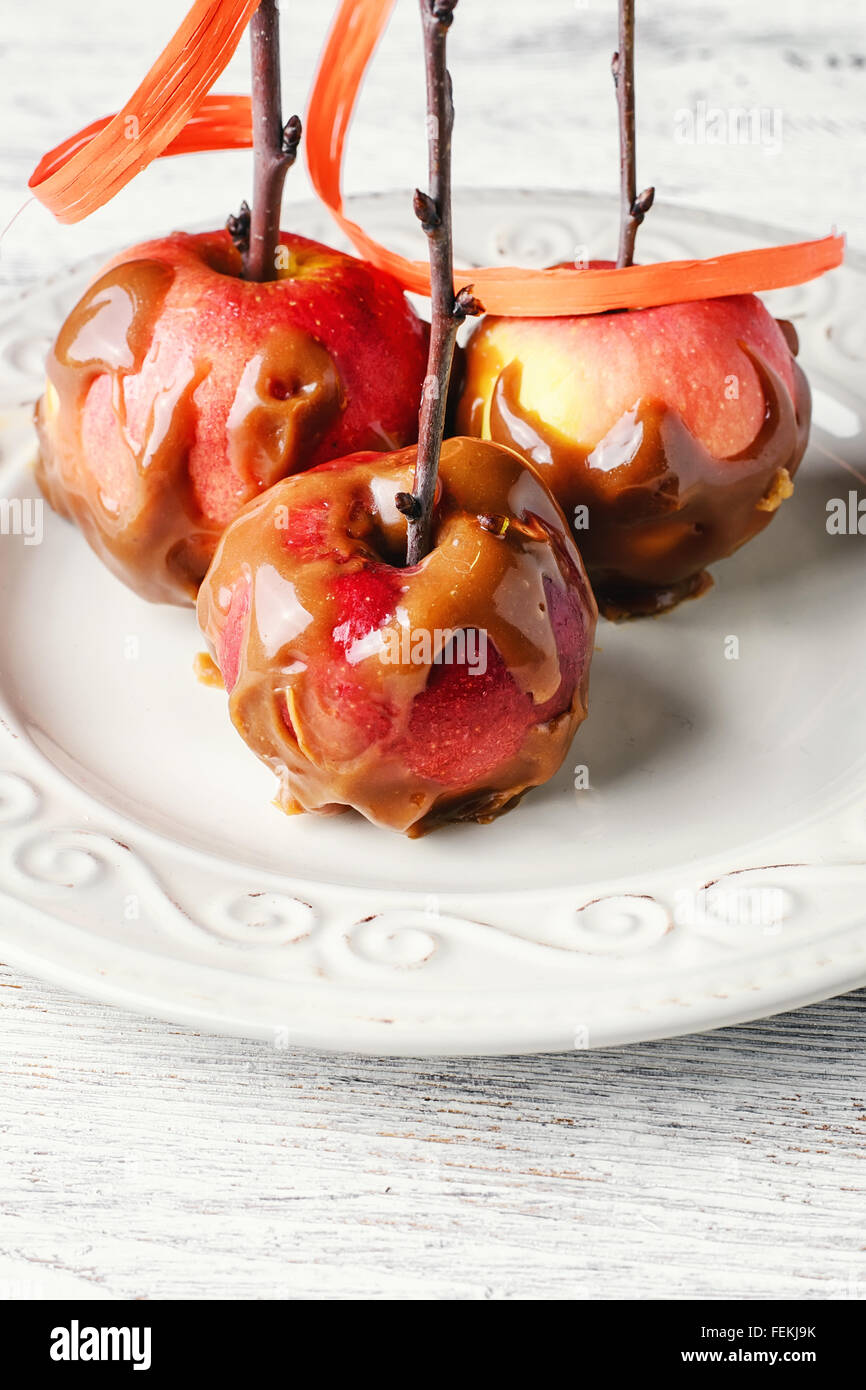 apples with toffee caramel decorated with branch Stock Photo - Alamy