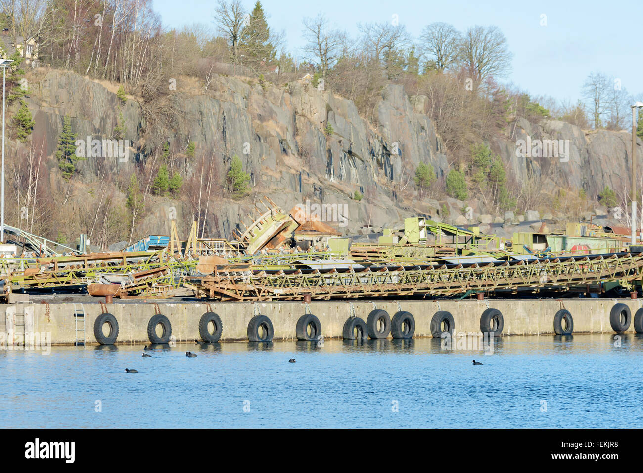 A pile of metal debris stored at the docks in an open pit quarry Stock ...