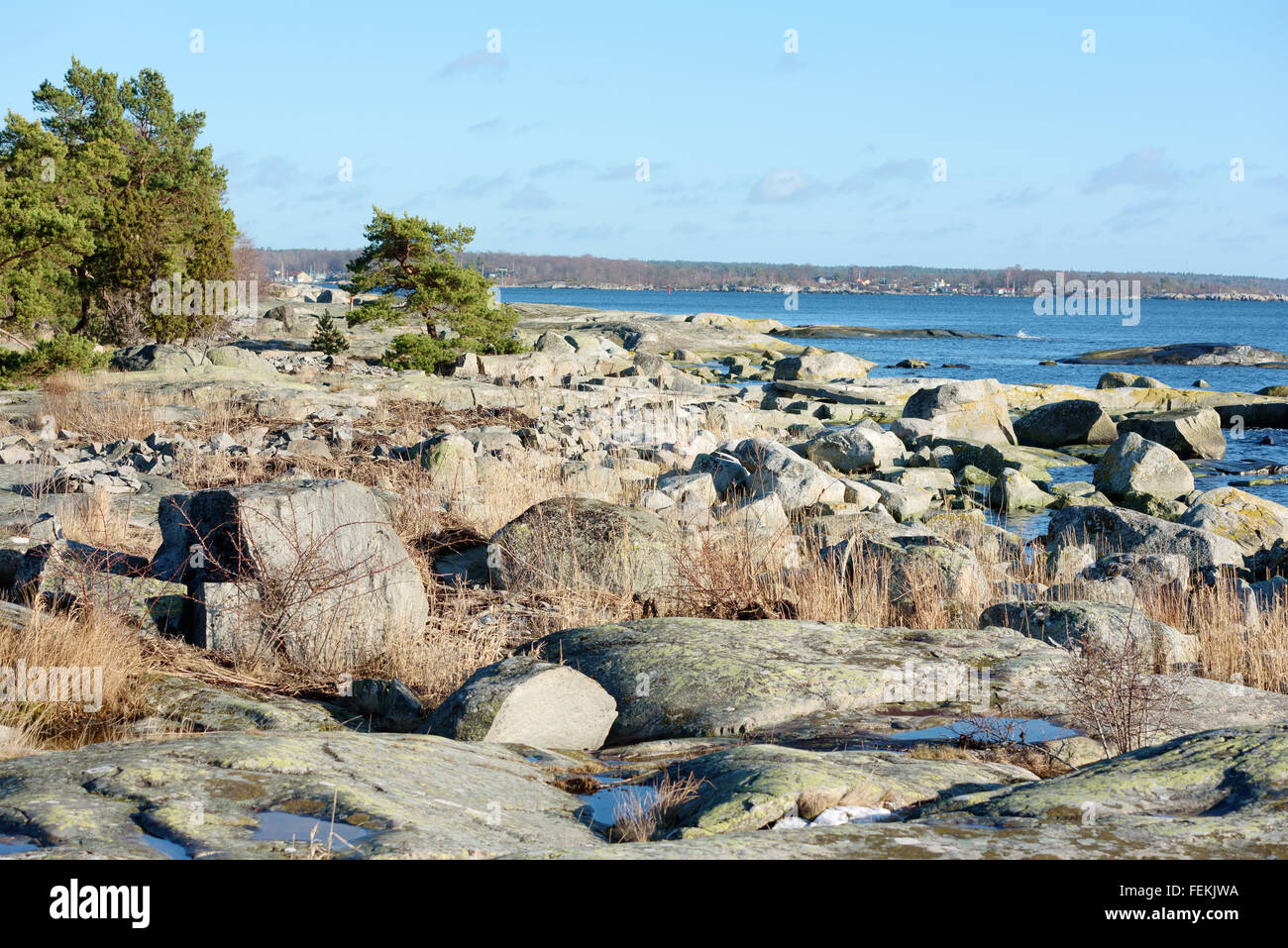 Granite boulders, rocks and some trees in the Swedish shoreline of the ...