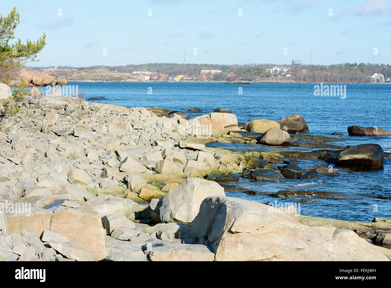 Granite boulders, rocks and some trees in the Swedish shoreline of the ...