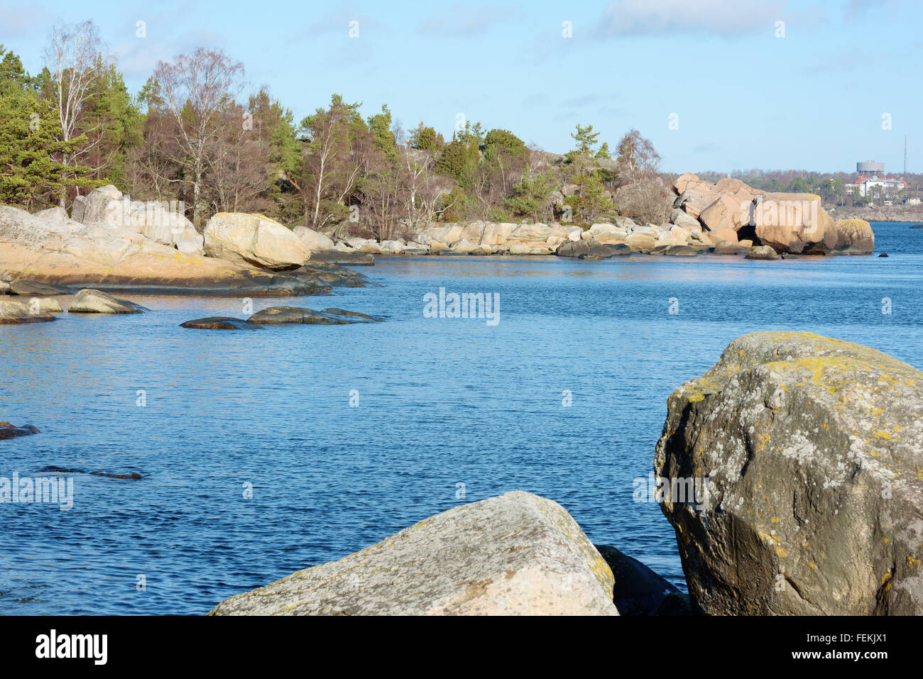 Granite boulders, rocks and some trees in the Swedish shoreline of the ...