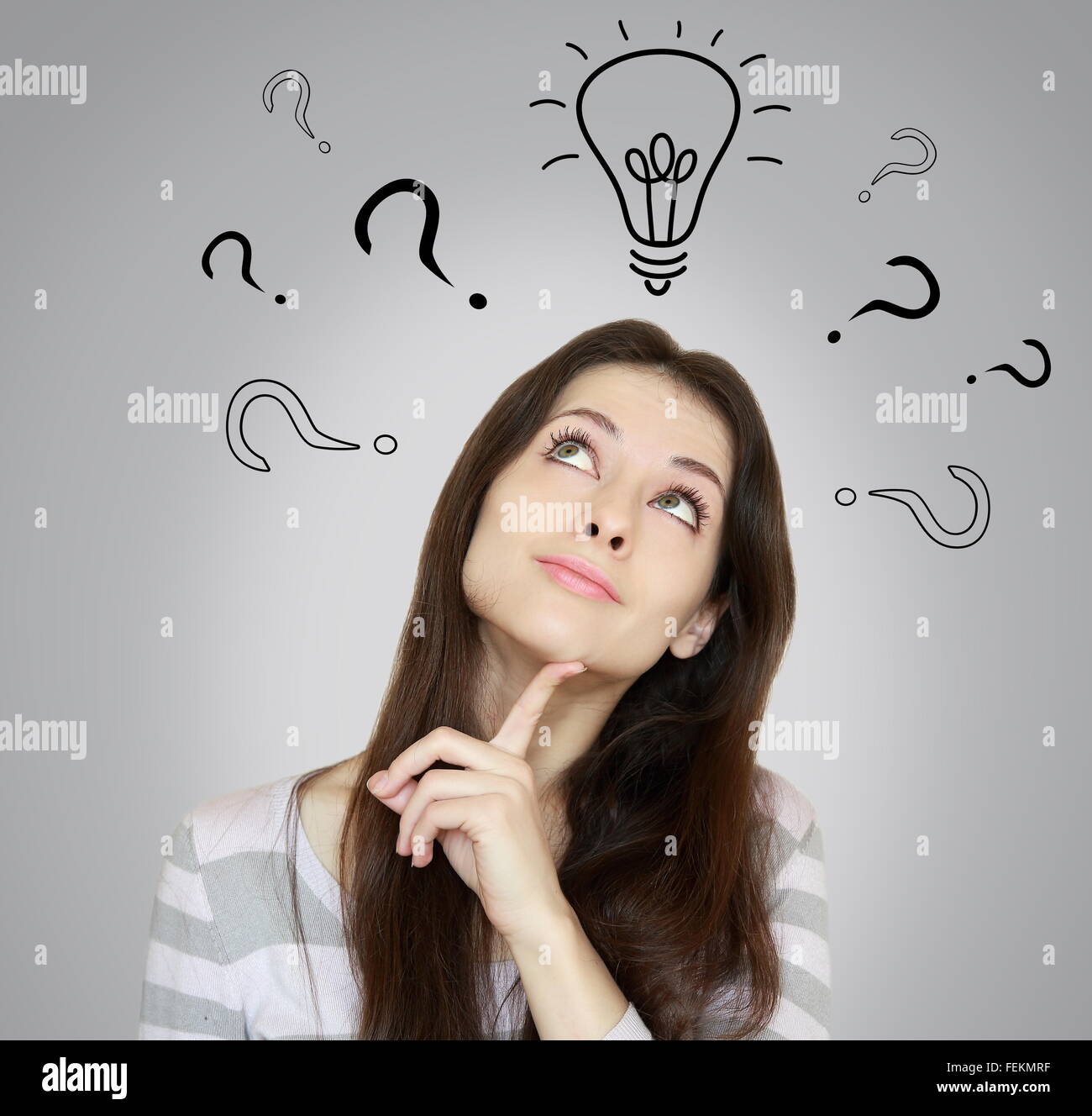 Thinking young woman with yes or no choice looking up with finger at ...