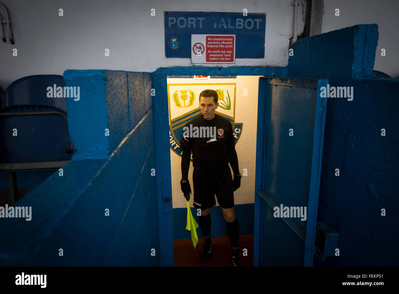 A referee's assistant waiting for the teams in the tunnel area before ...