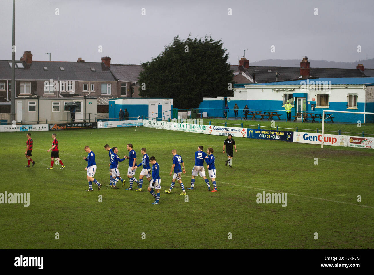Home players celebrating as Port Talbot Town (in blue) score their ...