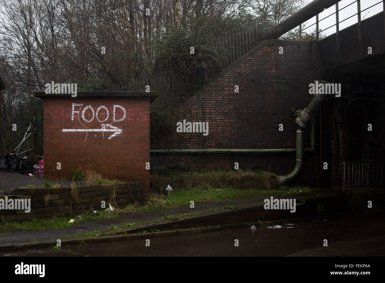 A painted sign advertising 'food' on a wall near the steelworks at Port ...